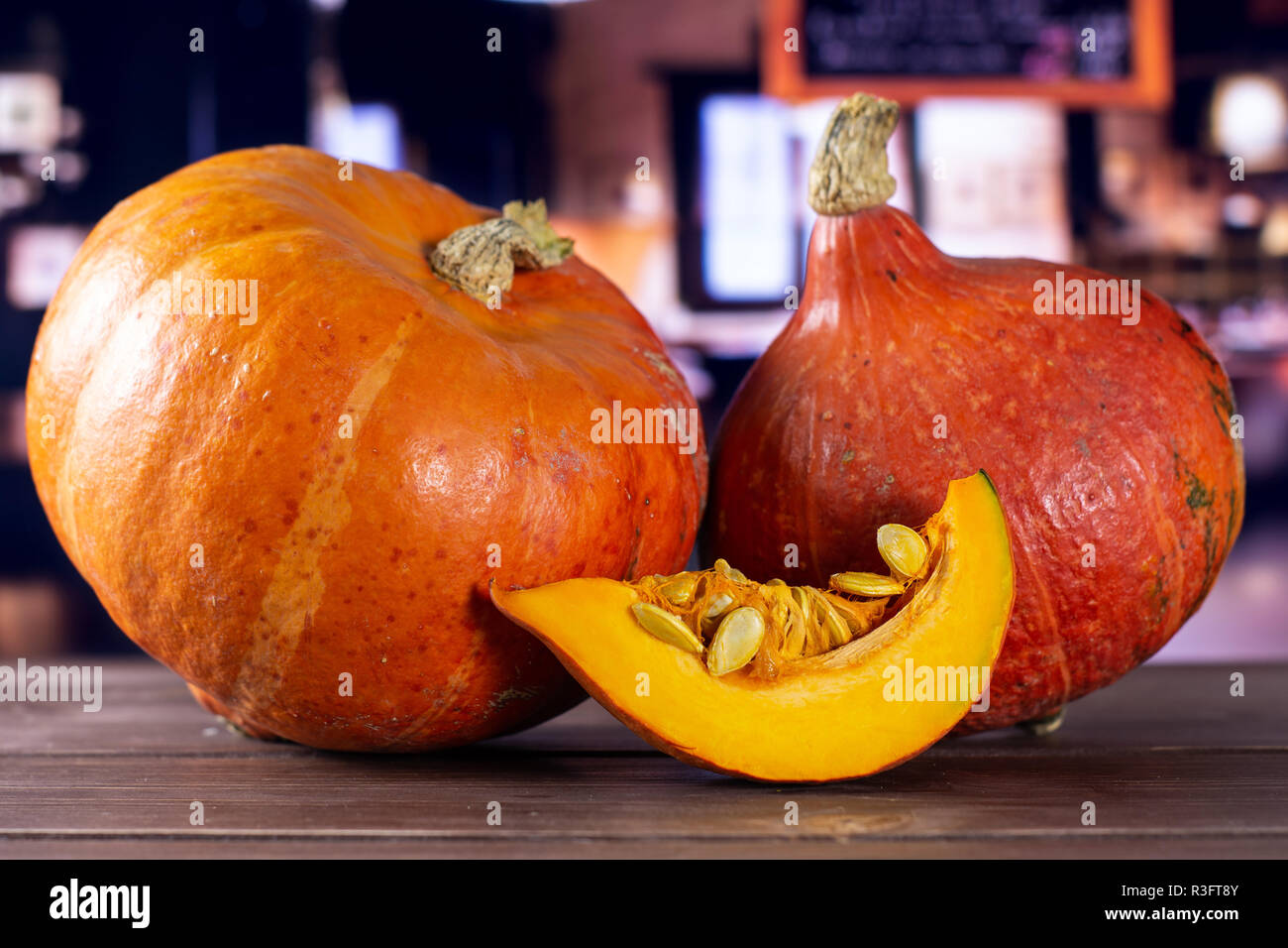 Group of two whole one slice of fresh red kuri pumpkin hokkaido variety ...