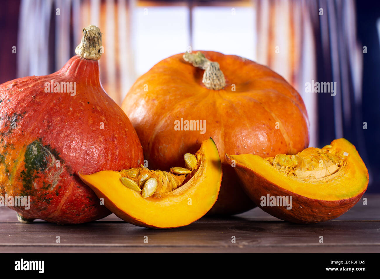 Group of two whole two slices of fresh red kuri pumpkin hokkaido ...