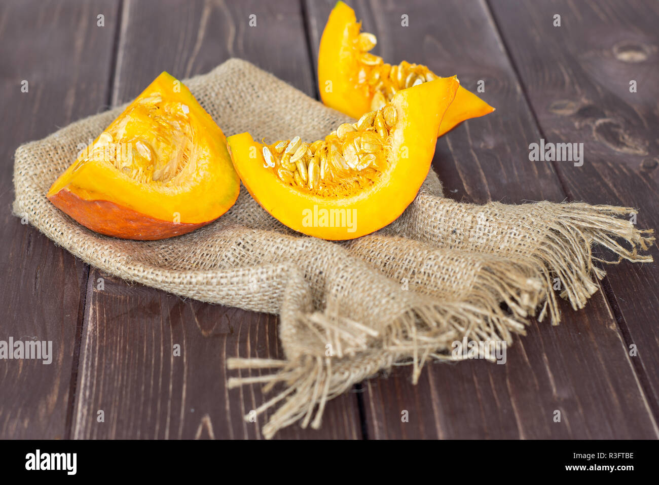 Group of three slices of fresh red kuri pumpkin hokkaido variety on ...