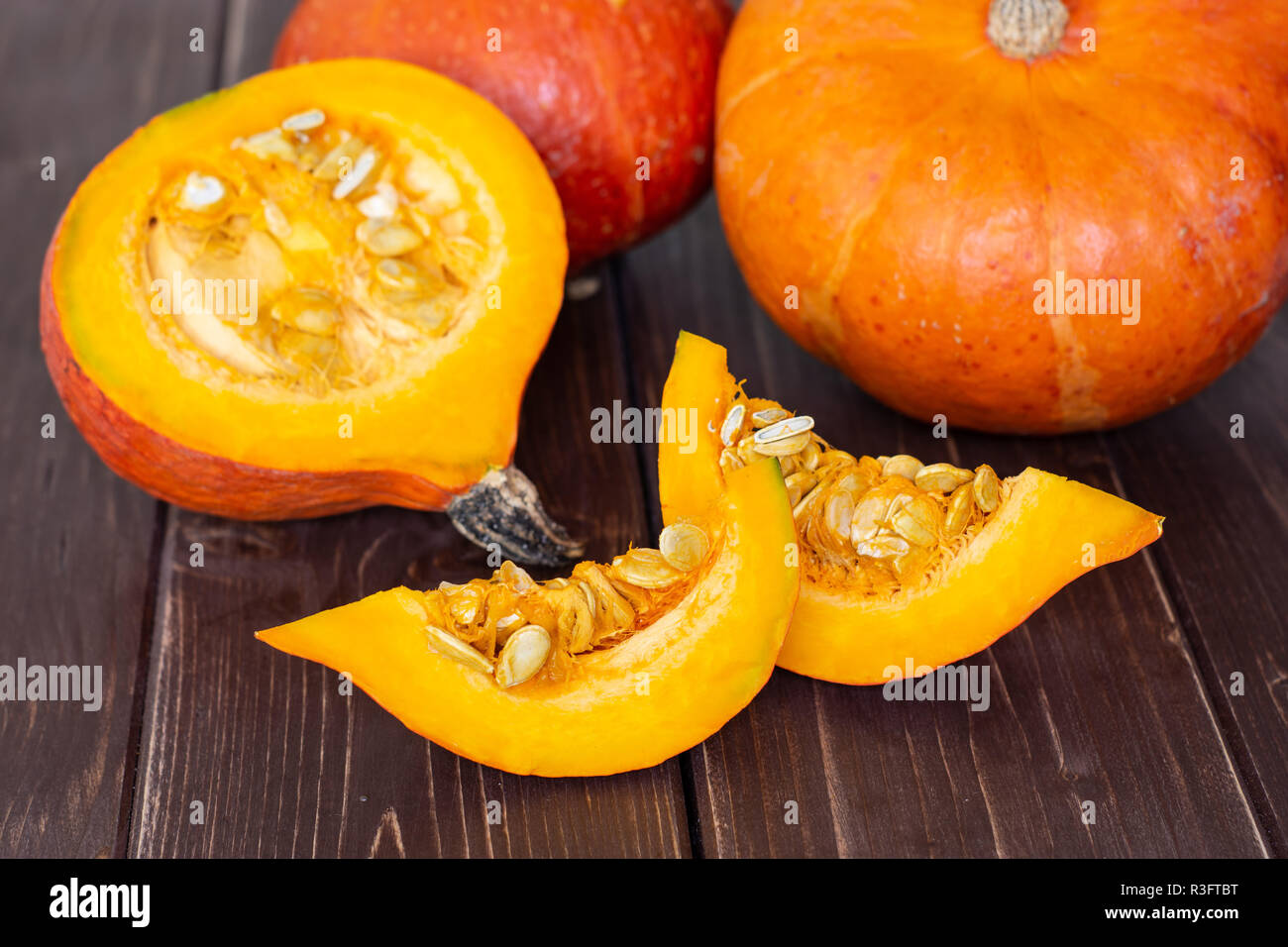 Group of two whole one half two slices of fresh red kuri pumpkin ...