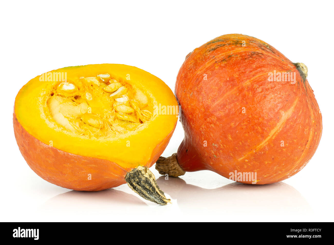 Group of one whole one half of fresh red kuri pumpkin hokkaido variety ...