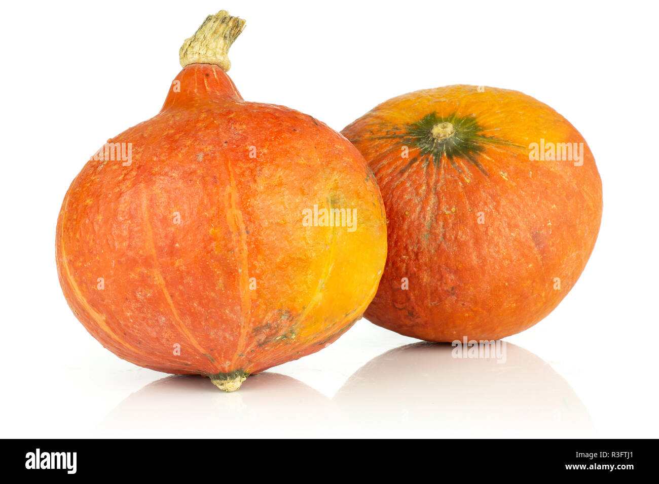 Group of two whole raw fresh red kuri pumpkin hokkaido variety isolated ...