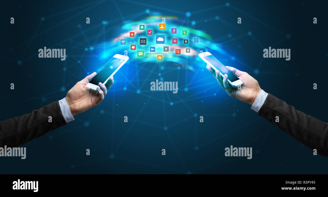 Two mobile phones syncing applications concept Stock Photo - Alamy