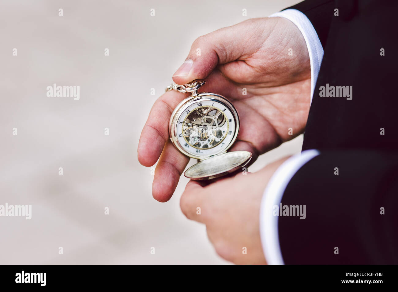 Hand holding watch on chain hi-res stock photography and images - Alamy