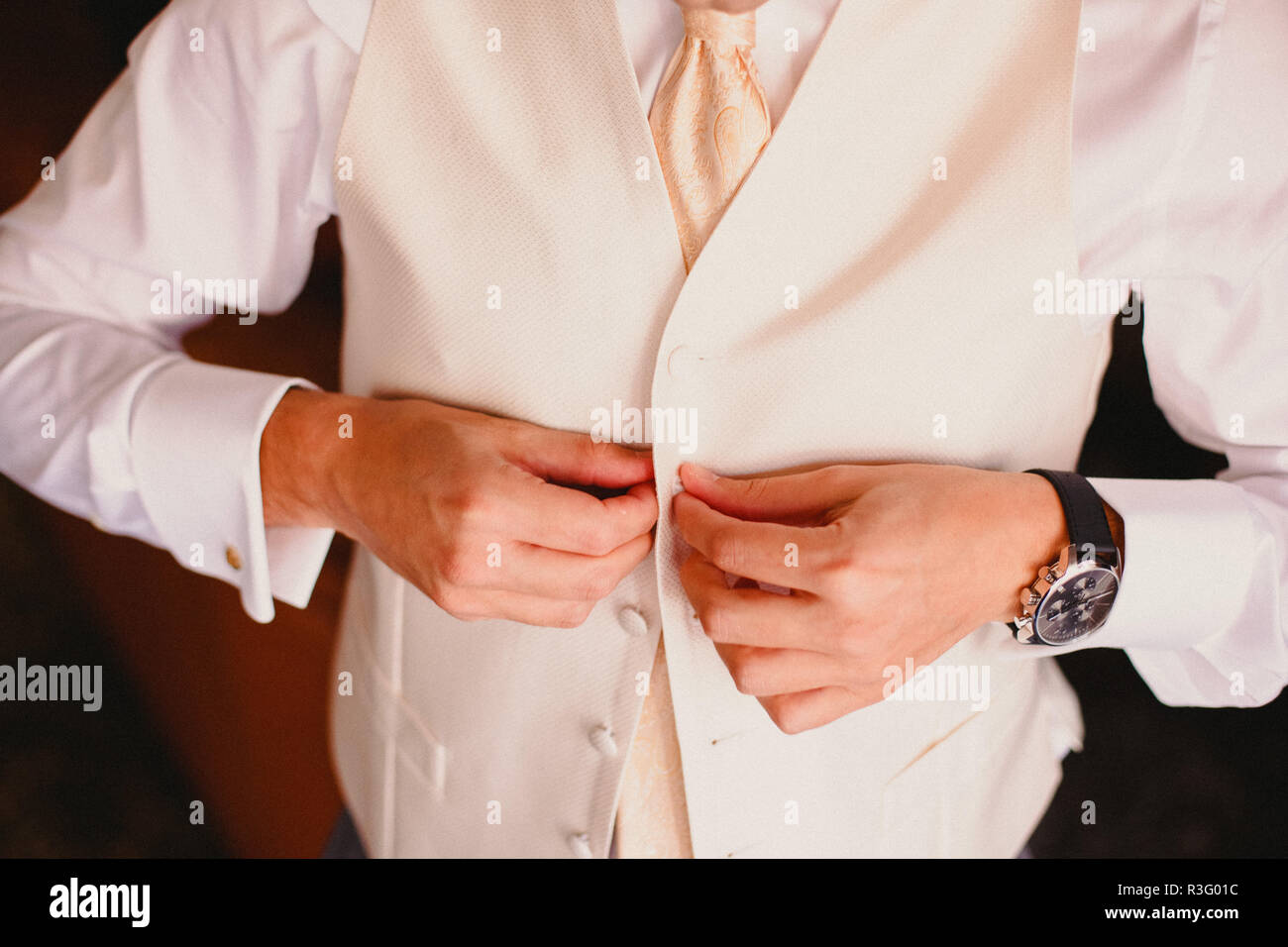 Groom getting ready to get married dressing Stock Photo - Alamy