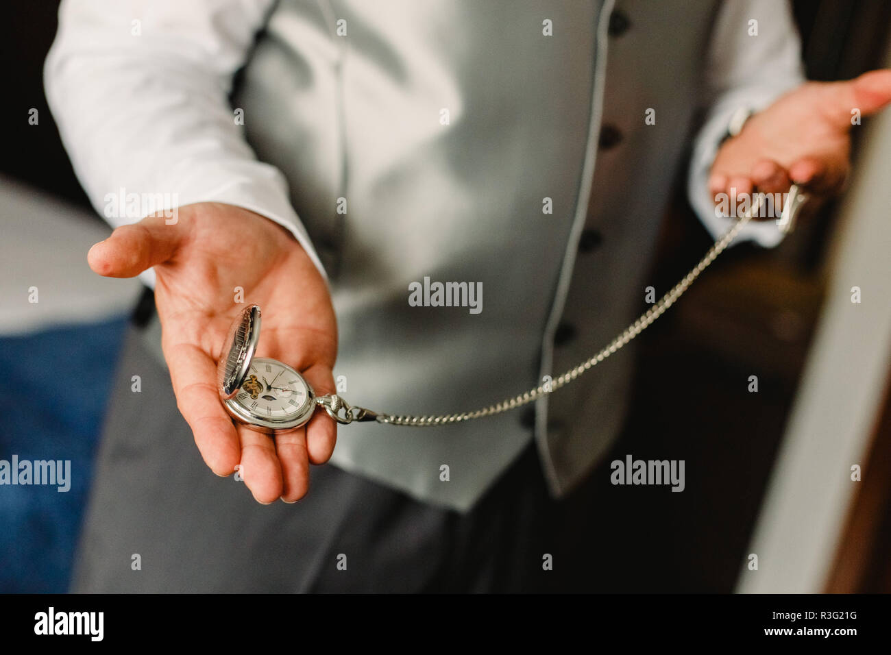 Hand holding watch on chain hi-res stock photography and images - Alamy