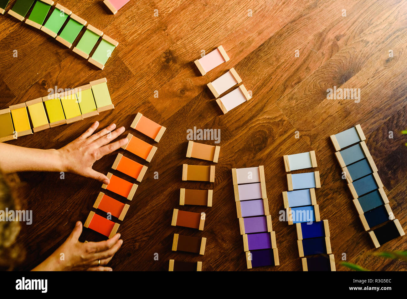 Children playing and learning with montessori color tablets Stock Photo ...