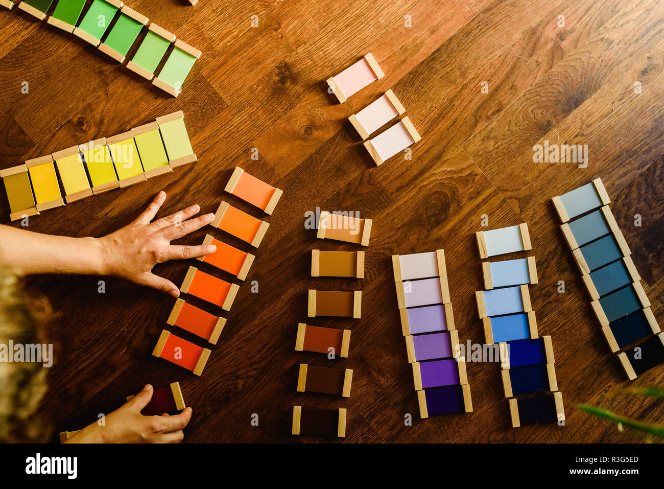 Children playing and learning with montessori color tablets Stock Photo ...