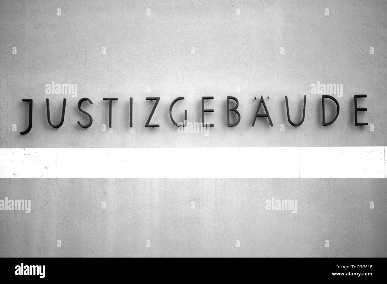 The lettering Justice Building on the facade of a district court Stock ...