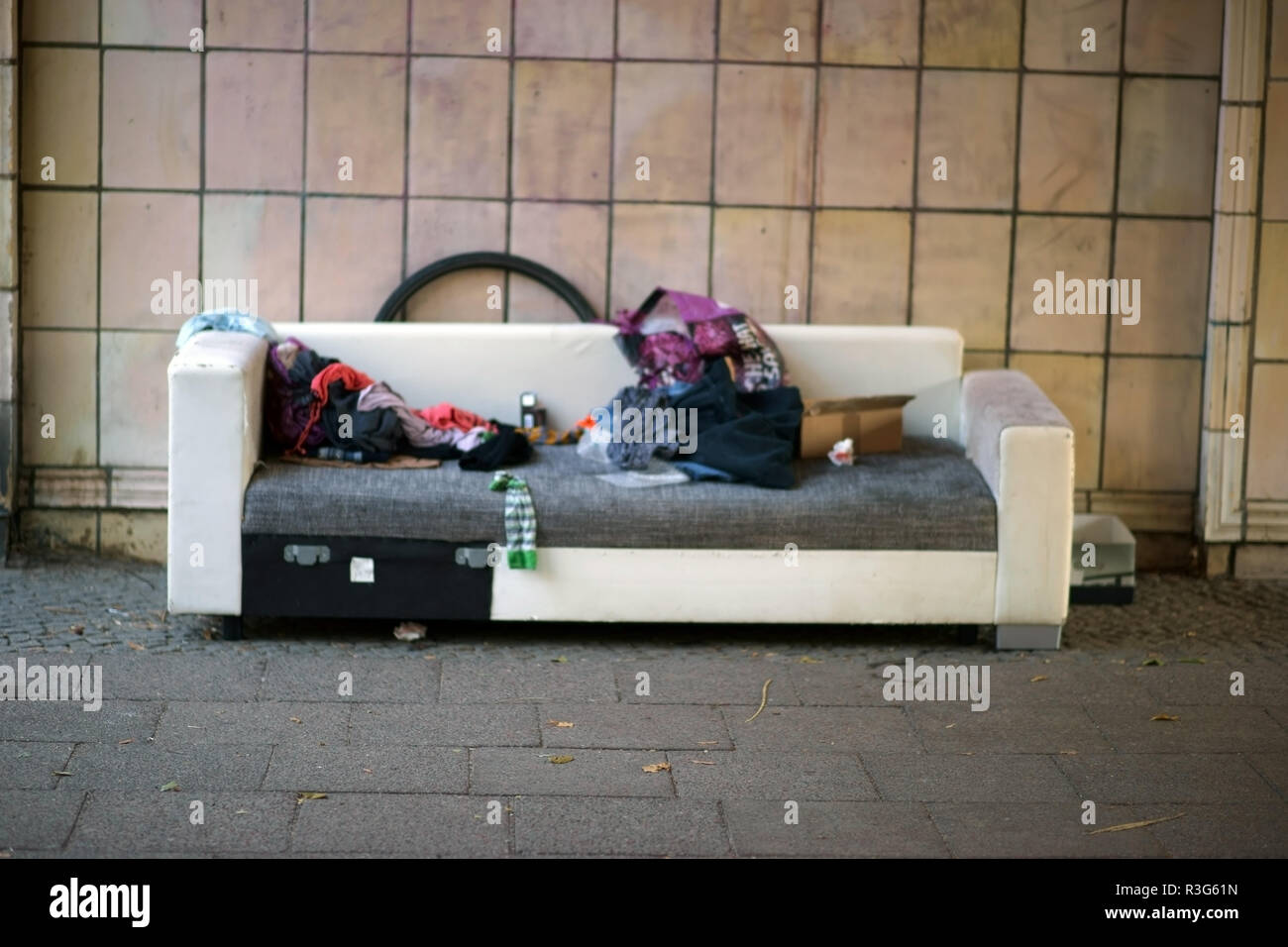 The sleeping berth of a homeless under a bridge with covers, rubbish ...