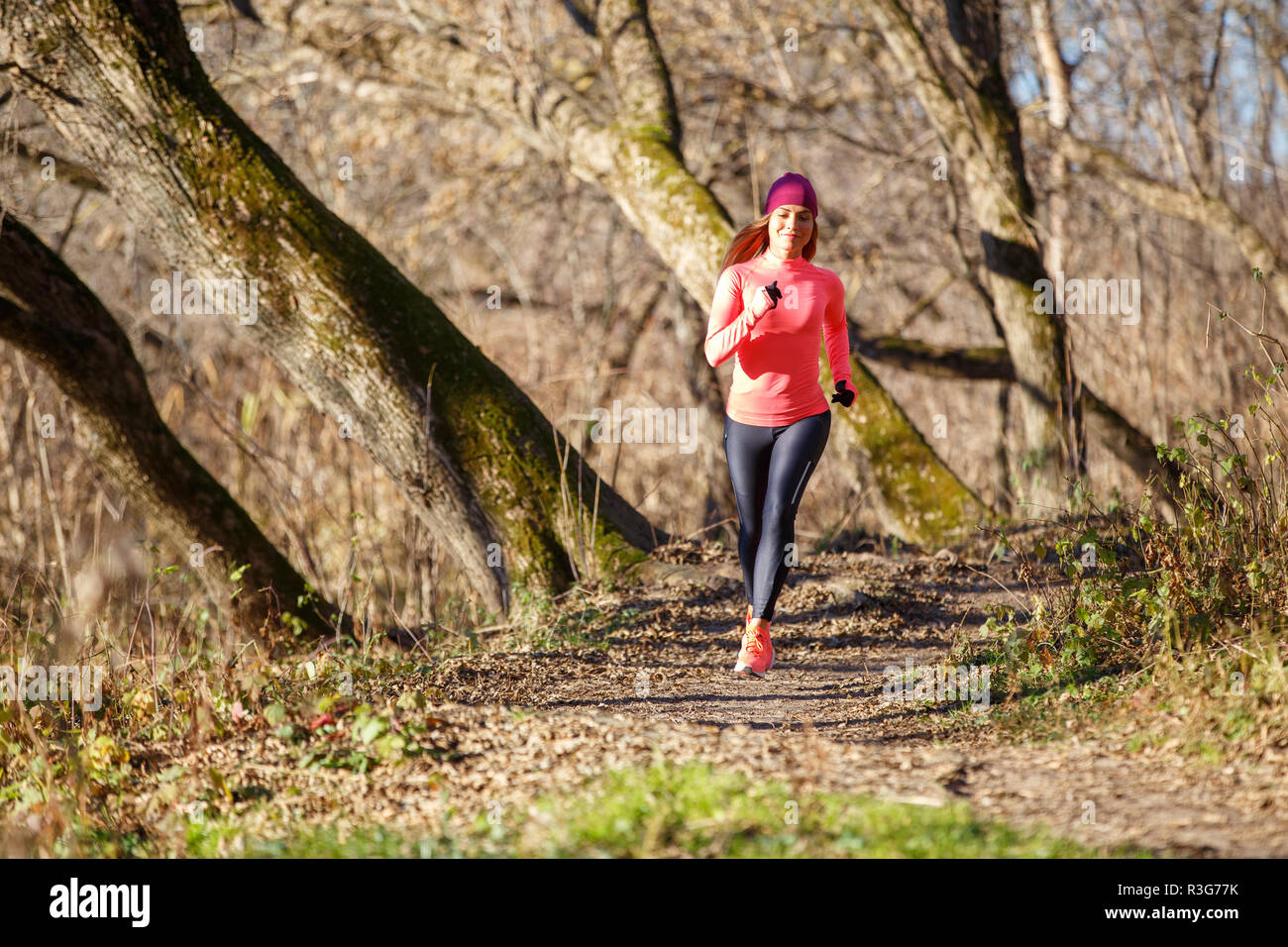 Young fitness woman jogging in autumn park in the morning. Attractive ...