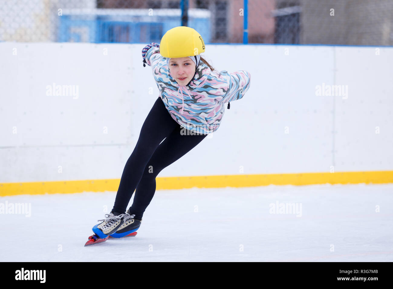 Short track sportswoman. Speed skating young girl on training rink ...