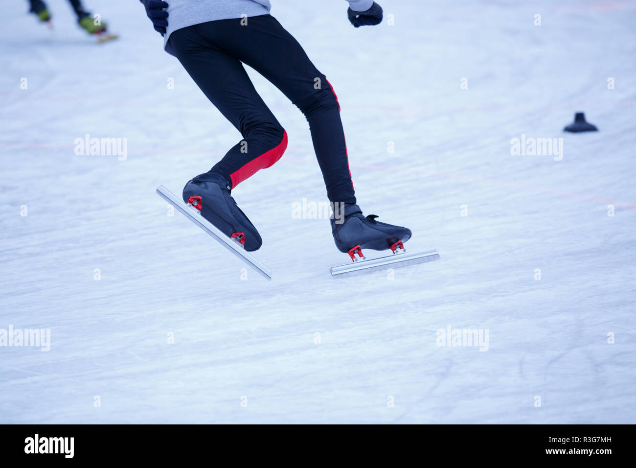 Short track professional sportsman skating on ice rink Stock Photo - Alamy