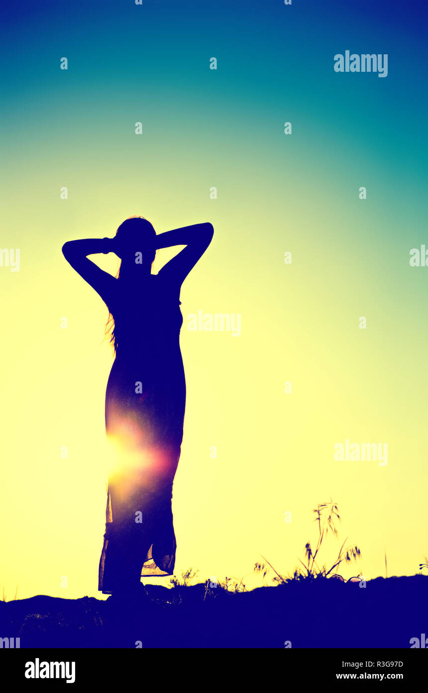 woman silhouette in front of a sunset Stock Photo - Alamy