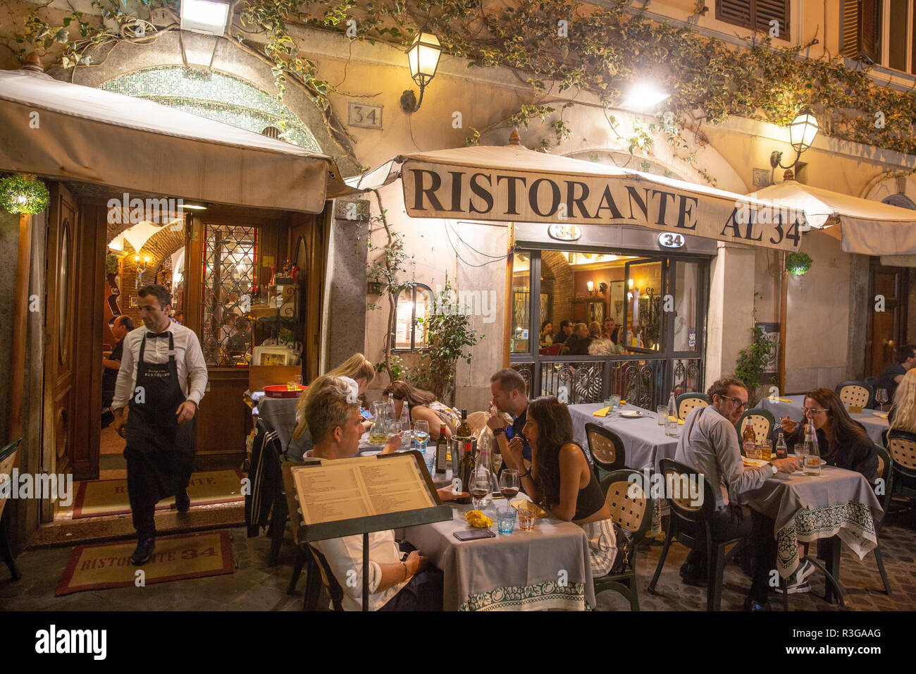 Traditional italian restaurant in Rome with diners eating dinner at ...