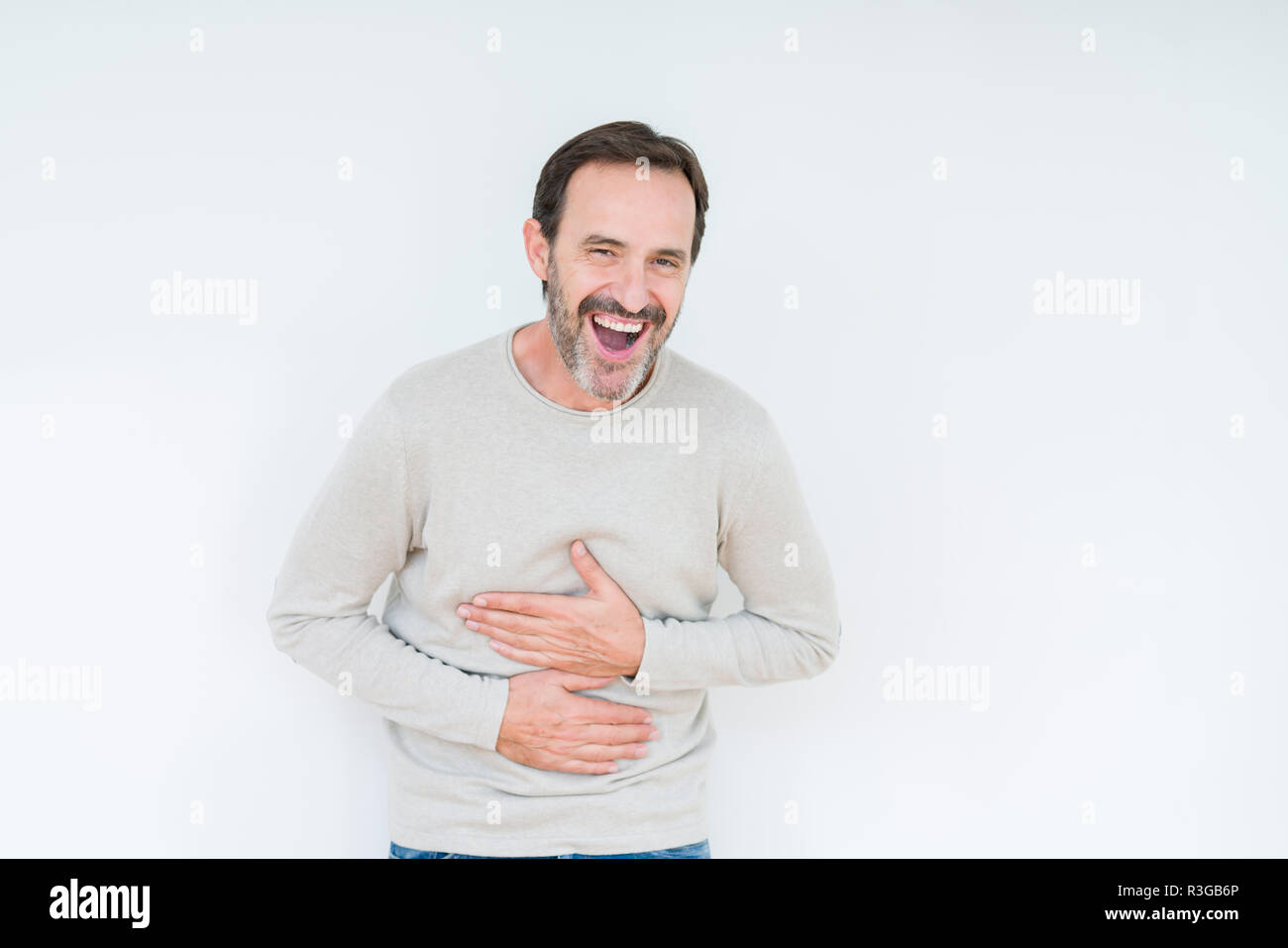 Elegant senior man over isolated background Smiling and laughing hard ...