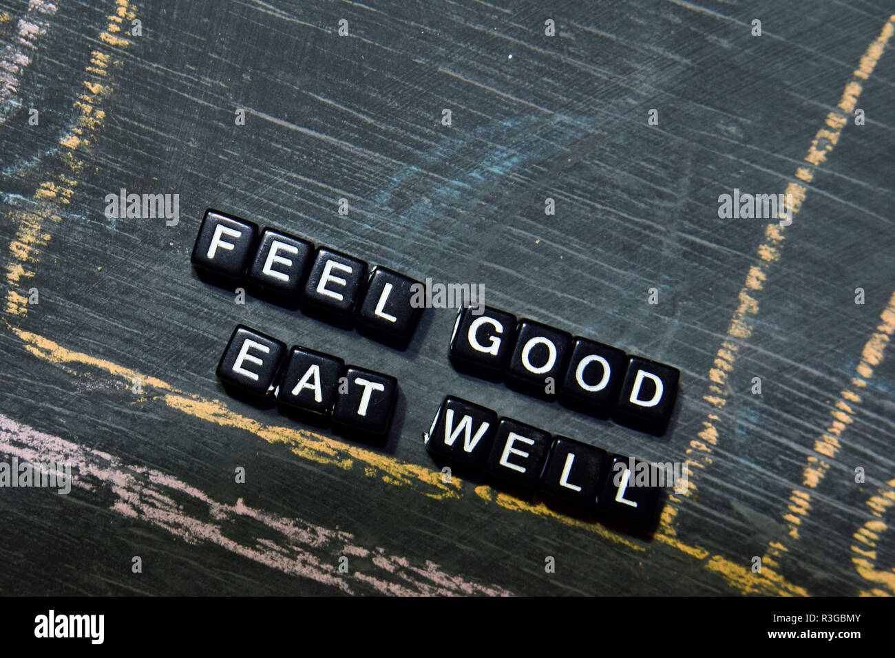 Feel Good Eat Well on wooden blocks. Cross processed image with ...