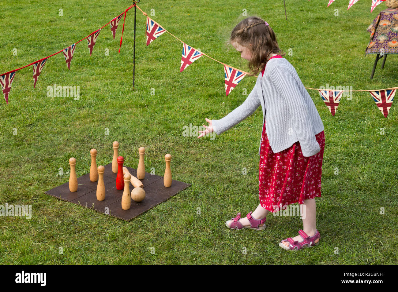 A six year old girl playing with an old-fashioned traditional classic ...