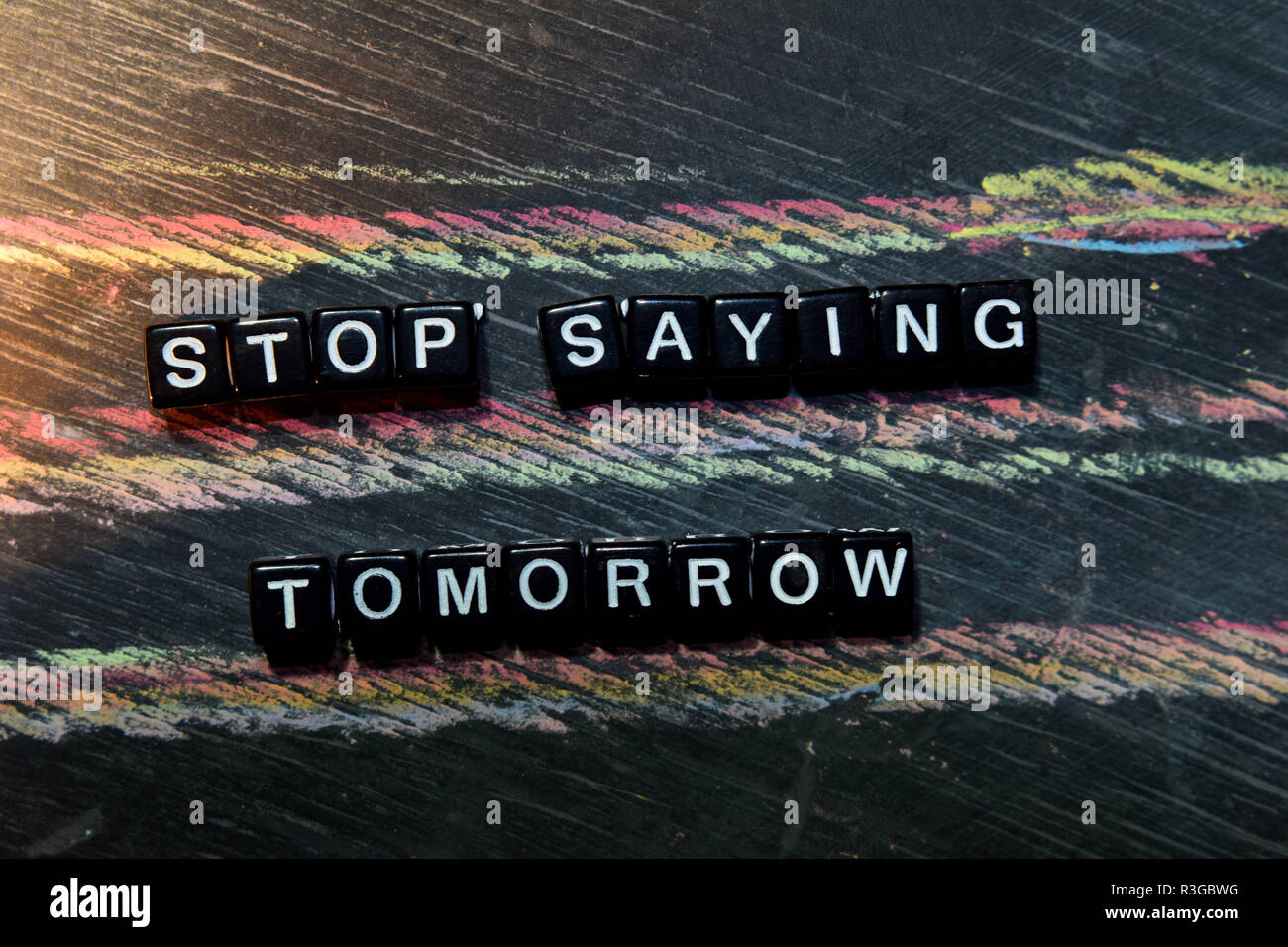 Stop Saying Tomorrow on wooden blocks. Cross processed image with ...