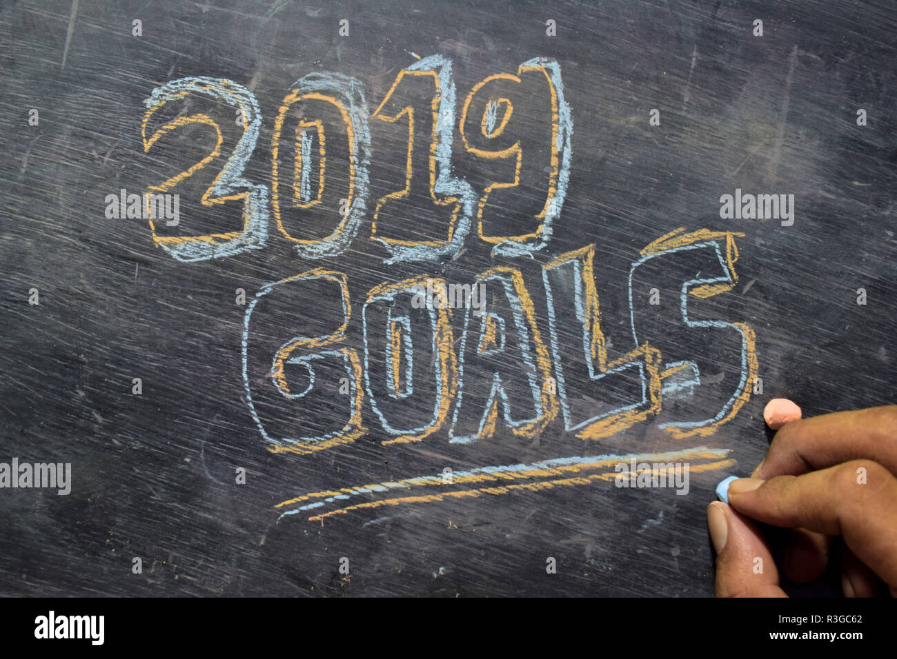 2019 Goals handwritten text with colorful chalk on blackboard ...