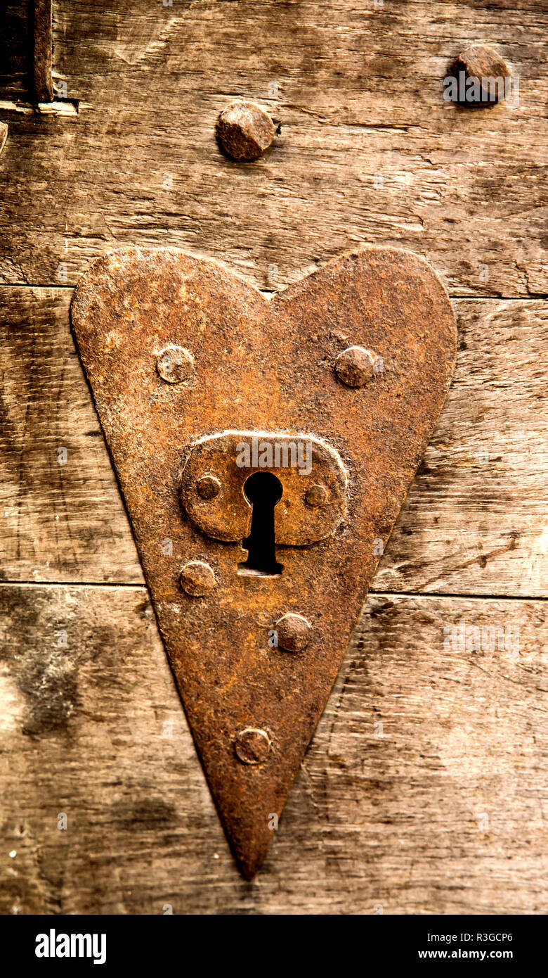 rusty metal ancient heart shaped lock with keyhole Stock Photo - Alamy
