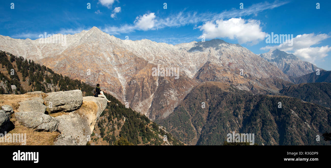 A tourist is enjoying the beautiful view of Dhauladhar Mountain ranges ...