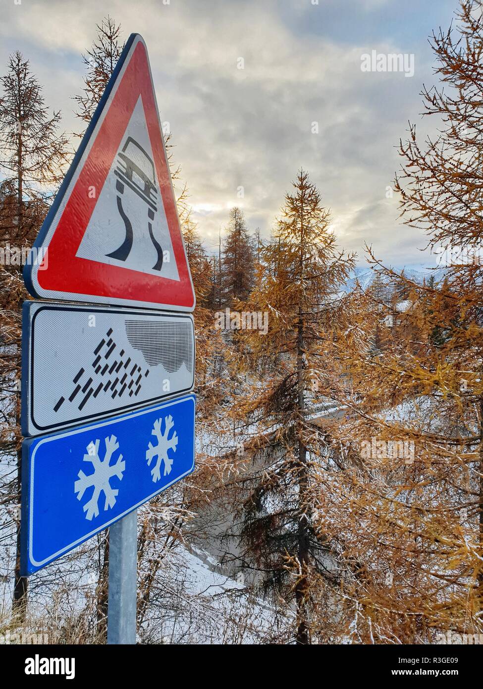 Alpine road in winter with snow warning sign Stock Photo - Alamy