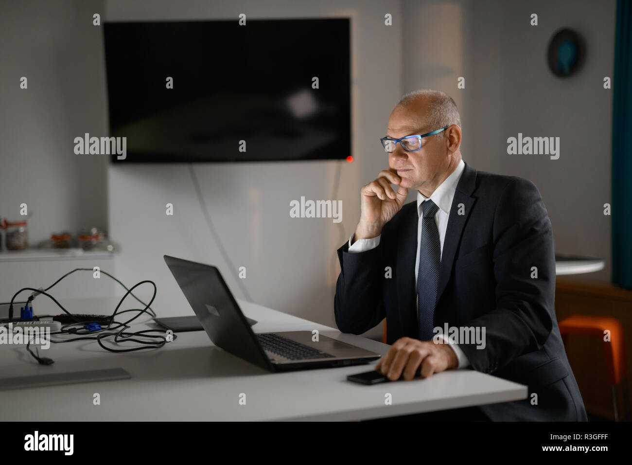 Senior Businessman With Laptop Thinking While Sitting In The Office ...