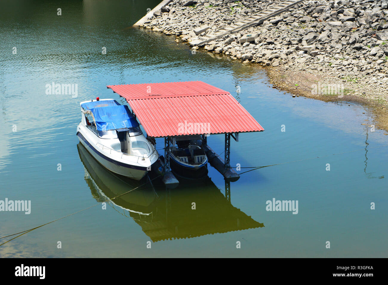 houseboat raft floating on reservoir river / speed boat with red roof ...
