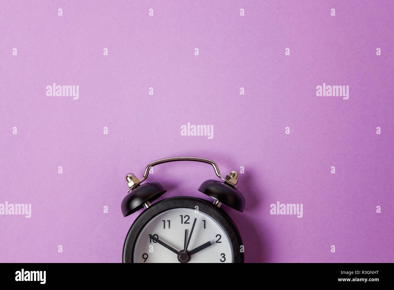 Ringing twin bell vintage classic alarm clock Isolated on purple violet ...