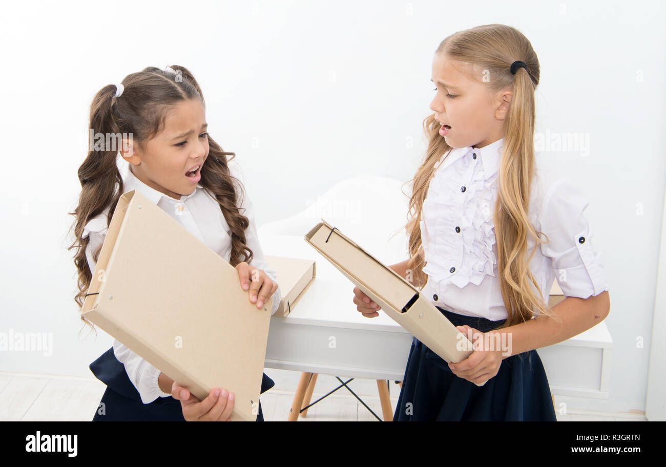 dispute of little kids girls fight with folders in classroom. Quarrel ...