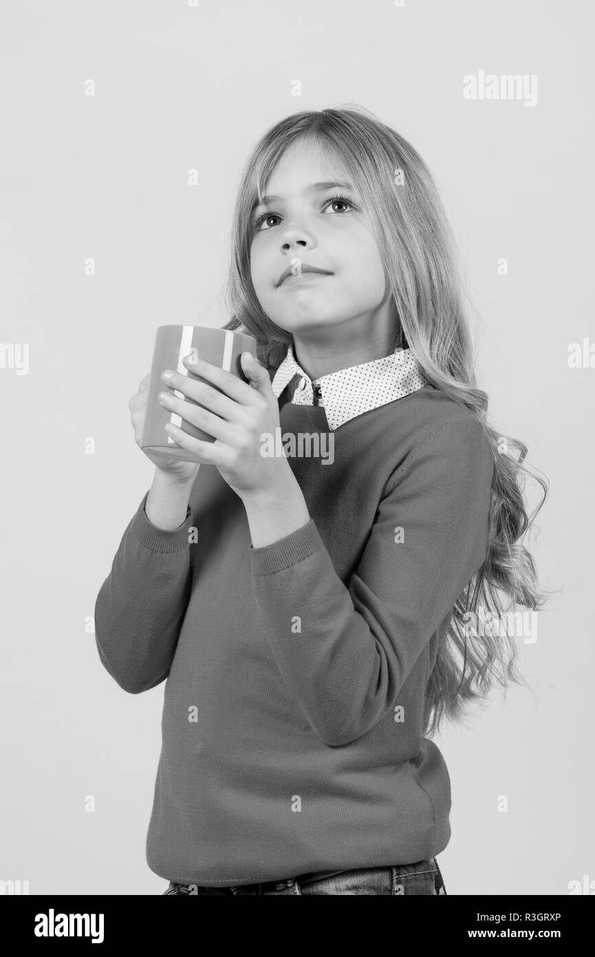 Health and healthy drink. Girl with long blond hair in red sweater with ...