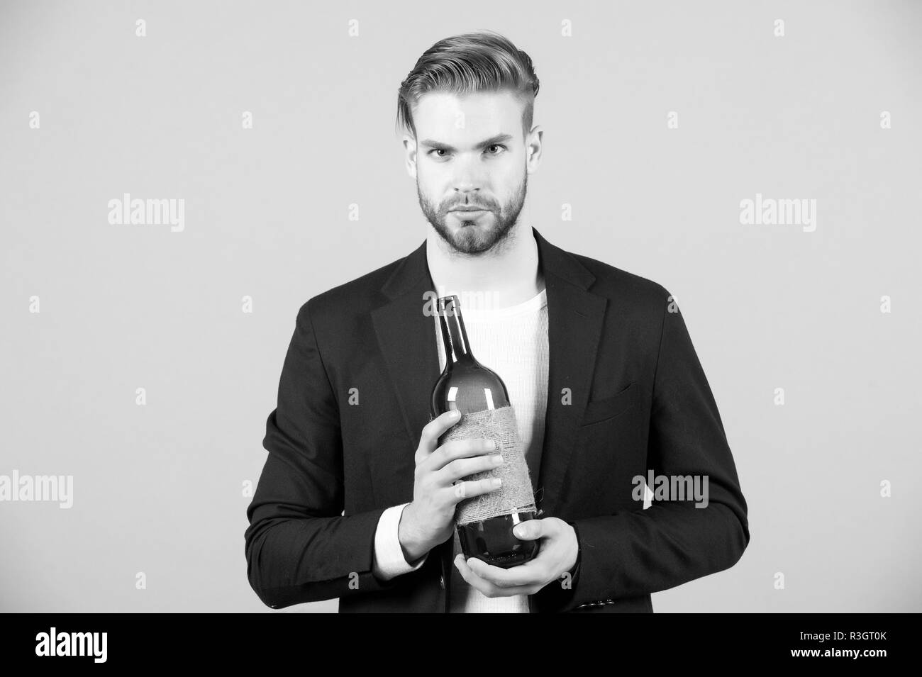 Boss with bottle of wine in hands. Bearded man hold alcoholic drink ...
