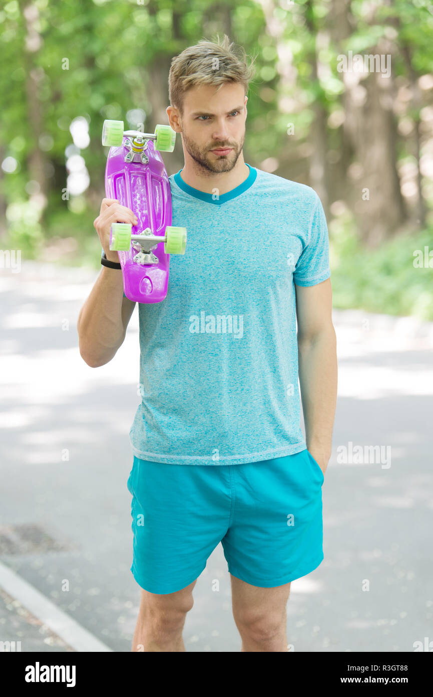 He will show his best in skateboarding. Guy carries penny board ready ...