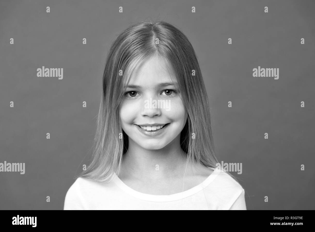 Beauty look and skincare. Little girl smile on violet background. Child ...