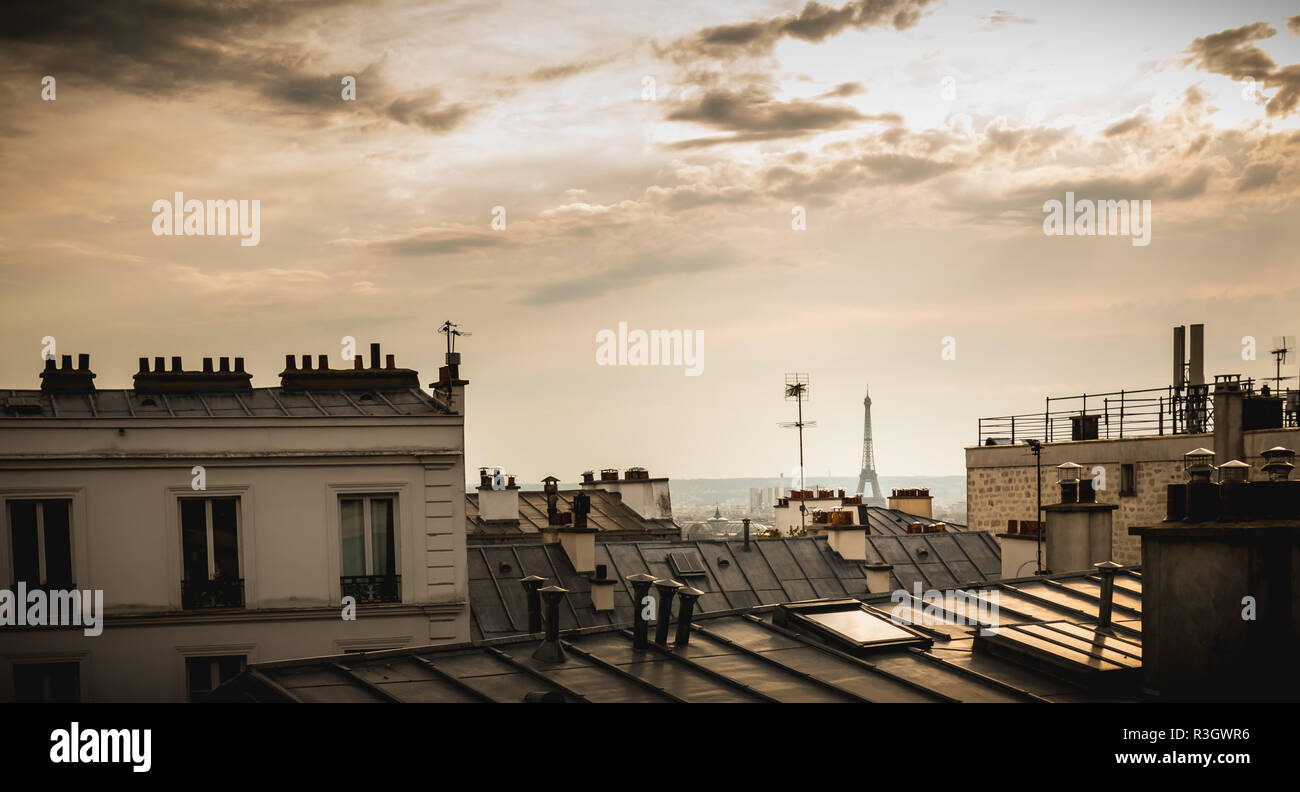 View of the Eiffel Tower above the rooftops of Paris in Montmartre ...