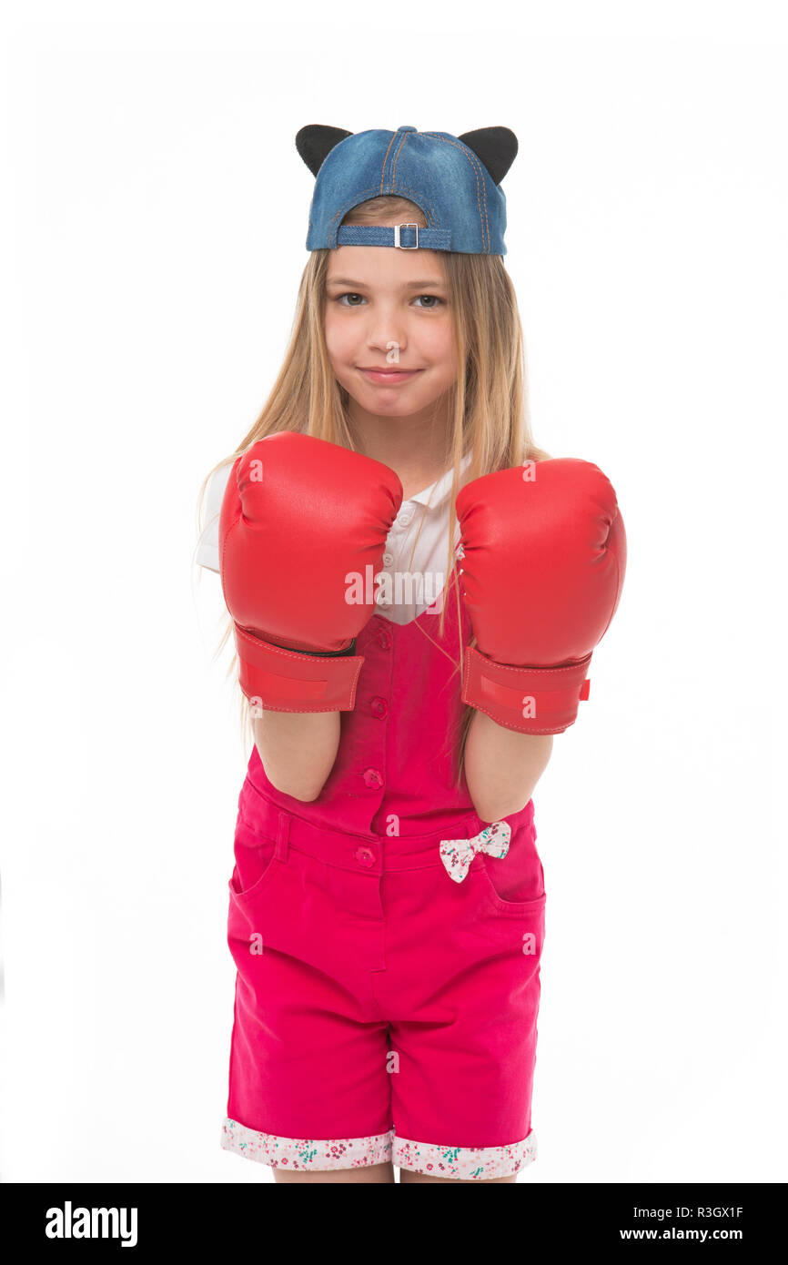 Lovely child wearing huge red boxing gloves. Girl in pink overalls ...