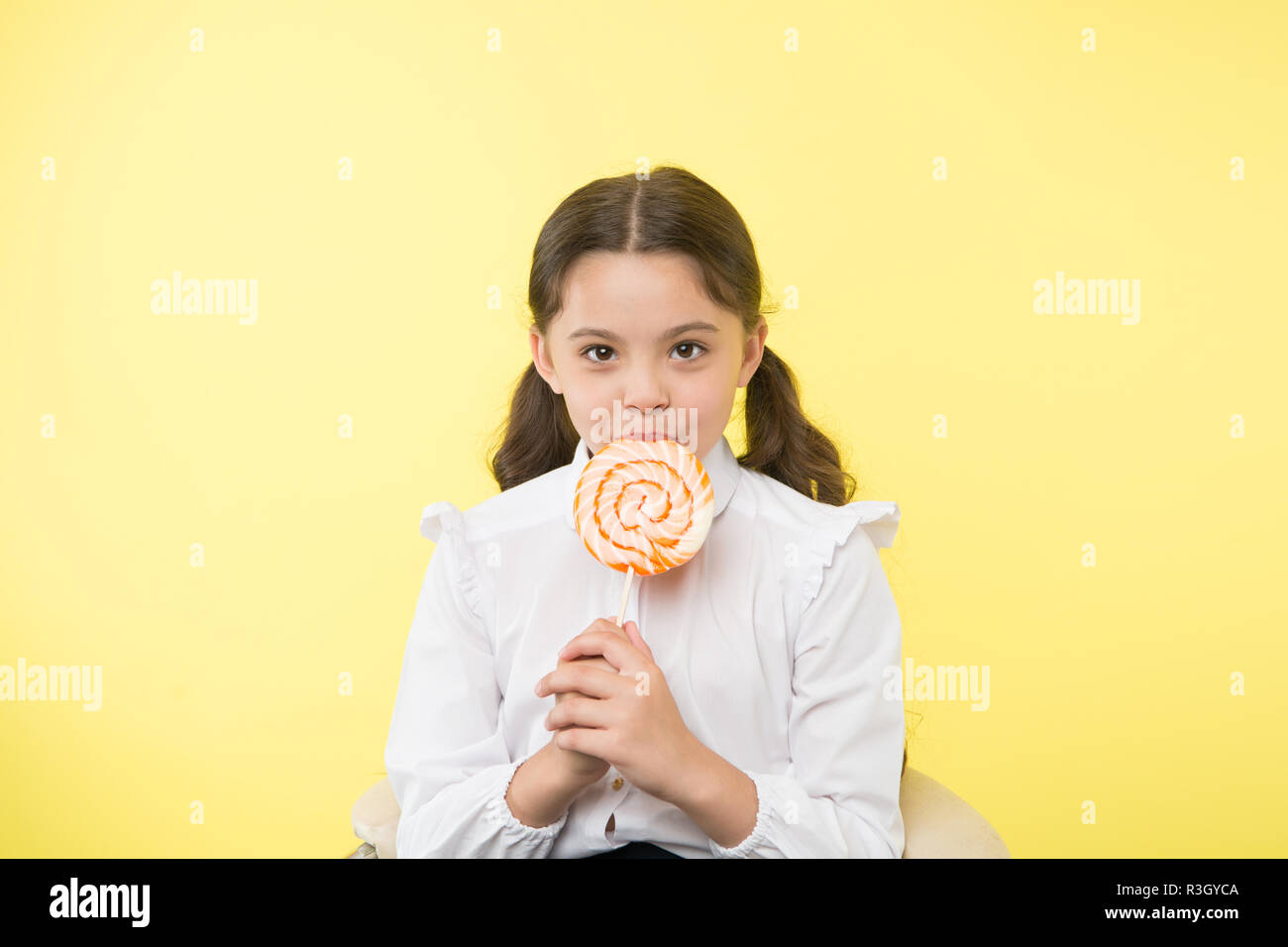 Malnutrition common problem. Girl pupil school uniform likes sweets ...