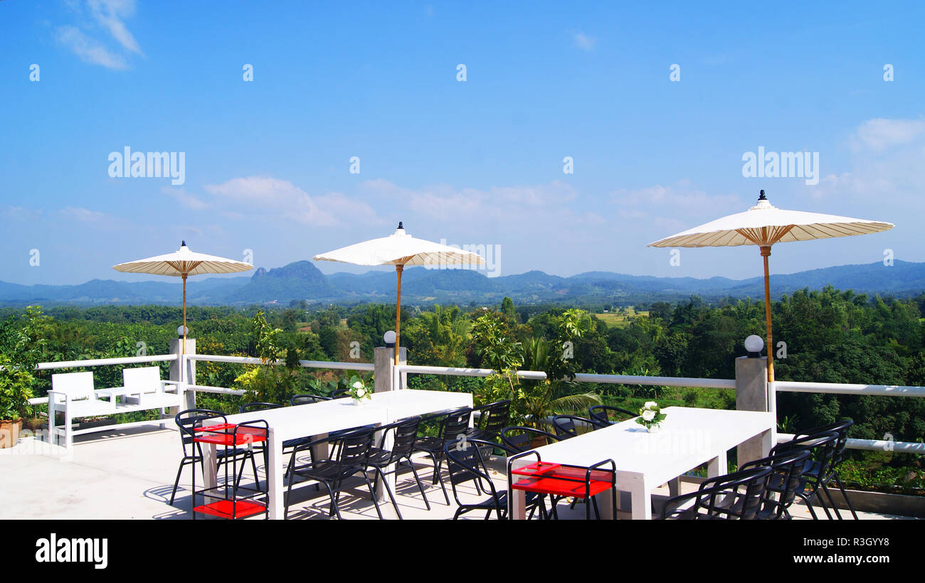 Dining table Outdoors on terrace With umbrella Mountain background ...