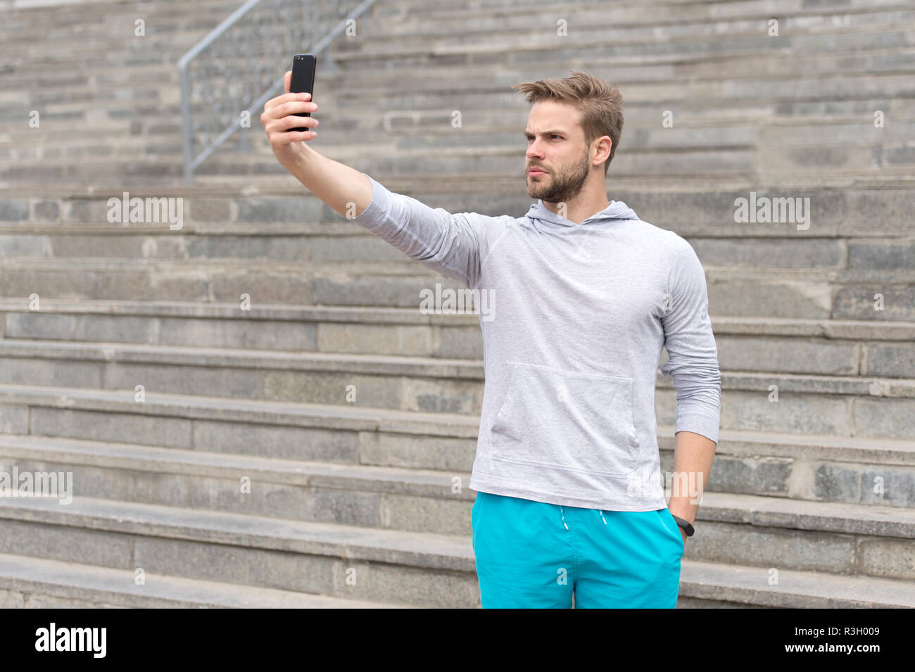 Selfie concept. Handsome man take selfie with smartphone. Athletic guy ...