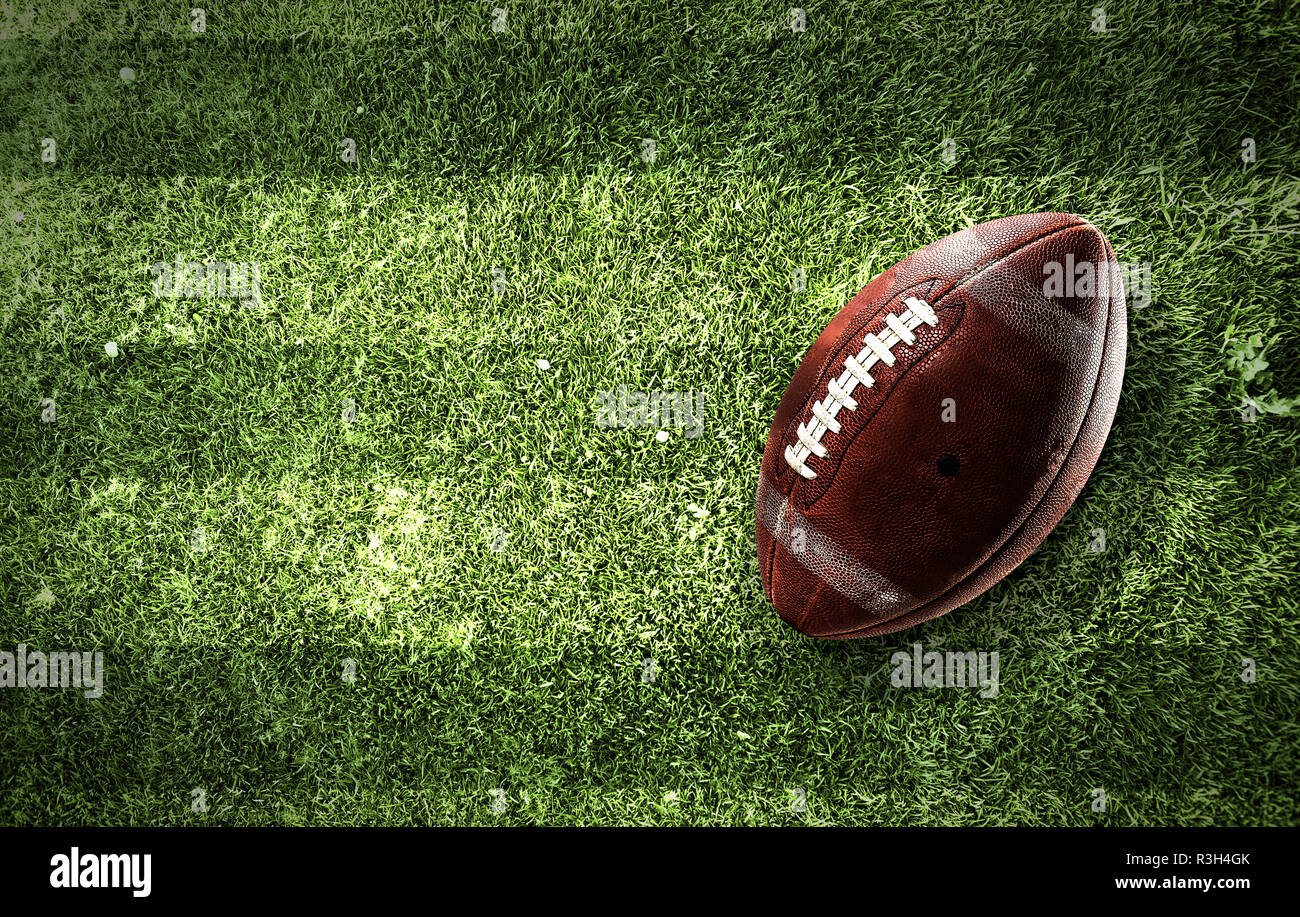 Rugby ball on grass Stock Photo - Alamy