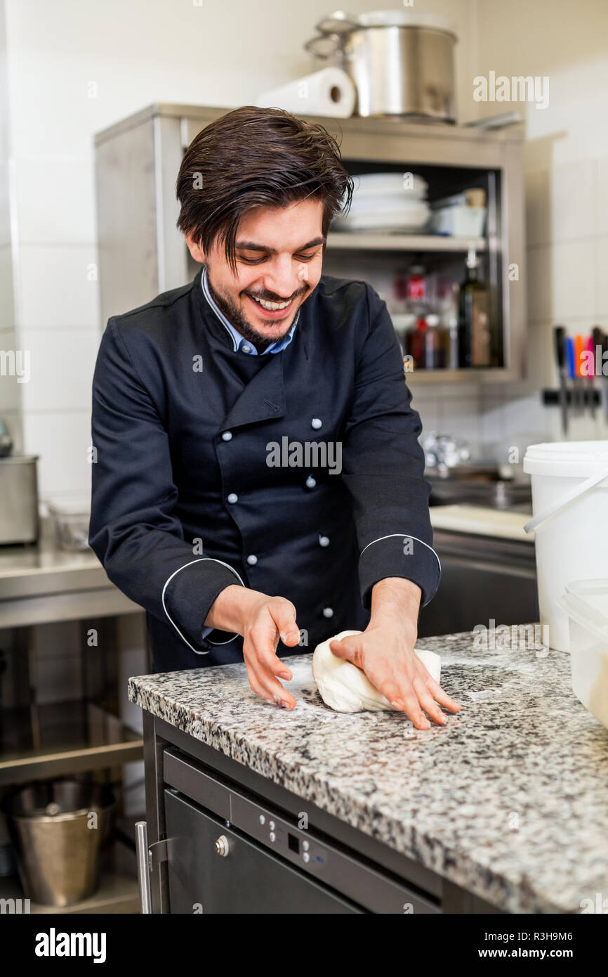 the young chef at the pizza dough throwing pizza maker Stock Photo - Alamy