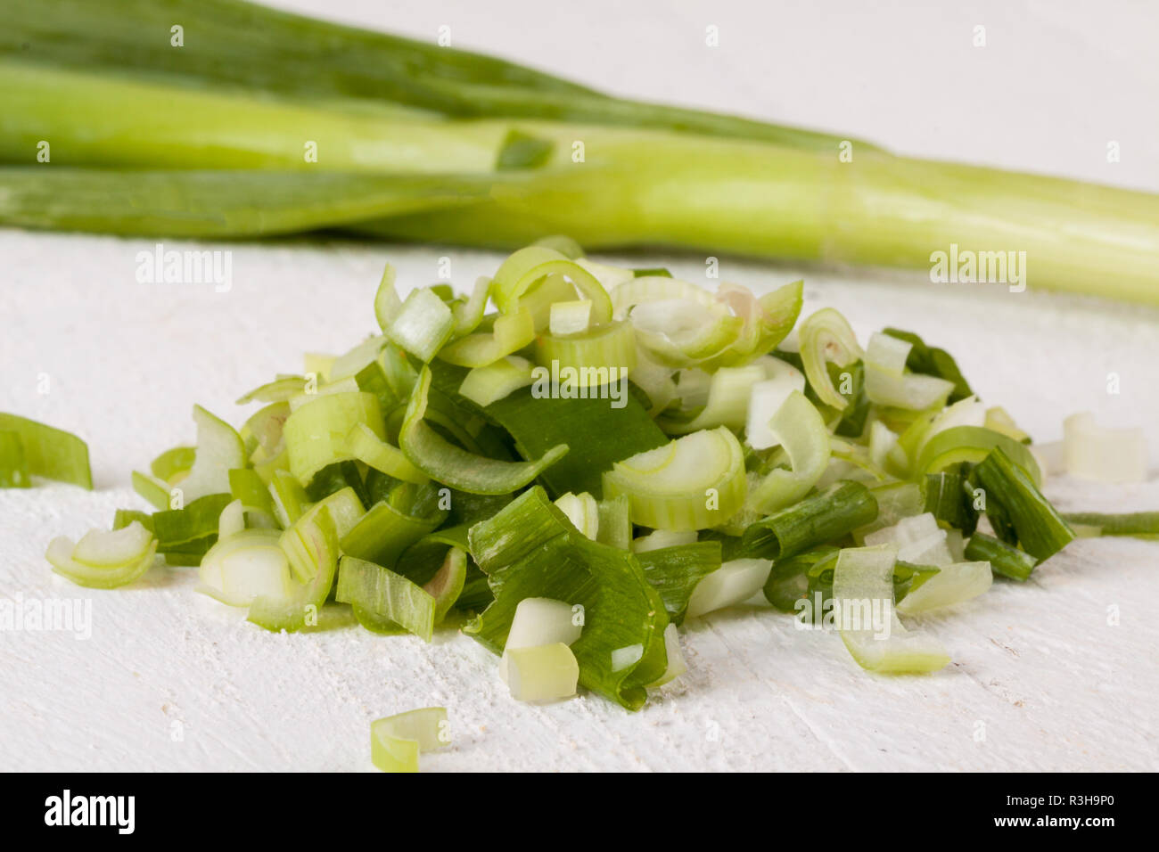 leek spring onions with root as a whole and cut as closeup Stock Photo ...