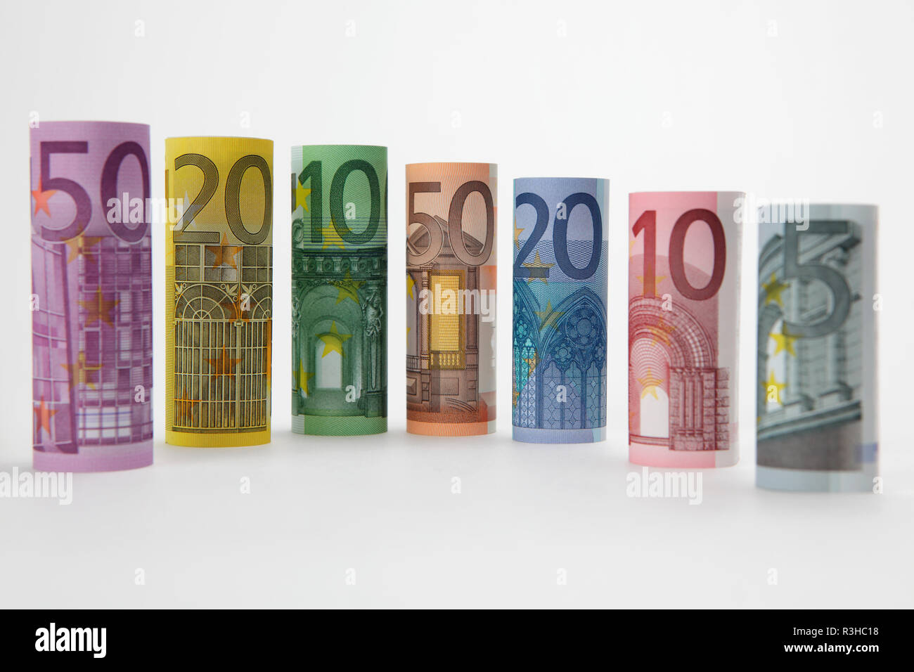 rolled up euro bills on white background Stock Photo - Alamy