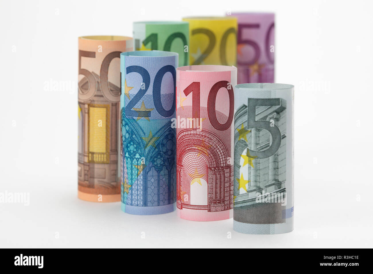 rolled up euro bills on white background Stock Photo - Alamy