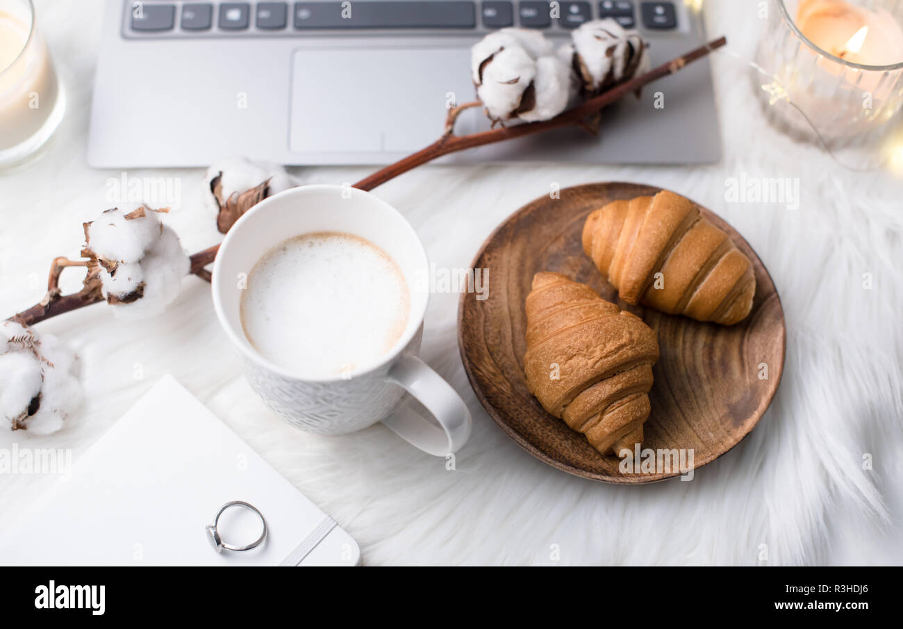Lady bloggers white work place with business details, laptop, coffee ...