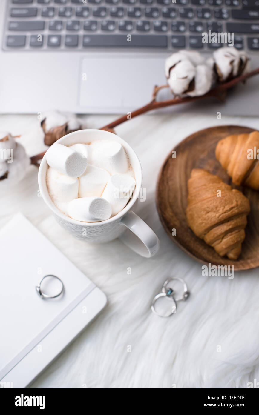 Cozy winter bloggers white work space with laptop, coffee with ...
