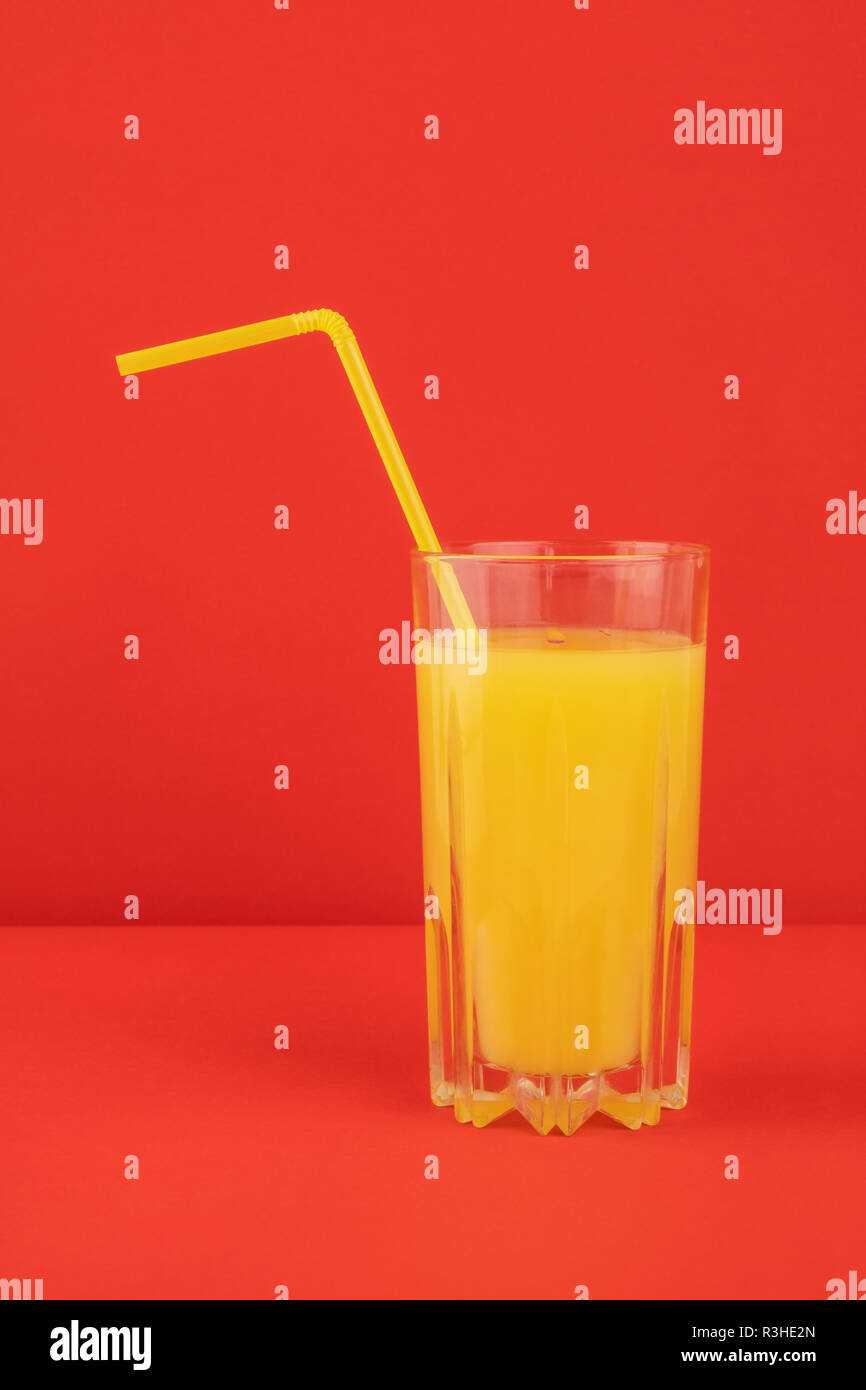 Orange cocktail drink on red background. Image of citrus juice glass at ...