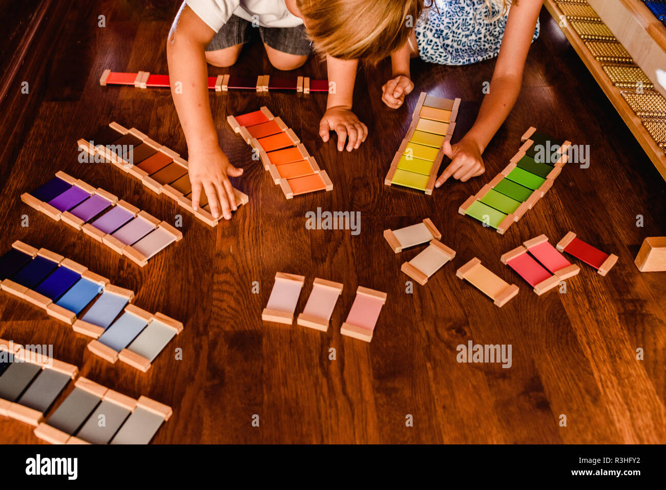 Children playing and learning with montessori color tablets Stock Photo ...
