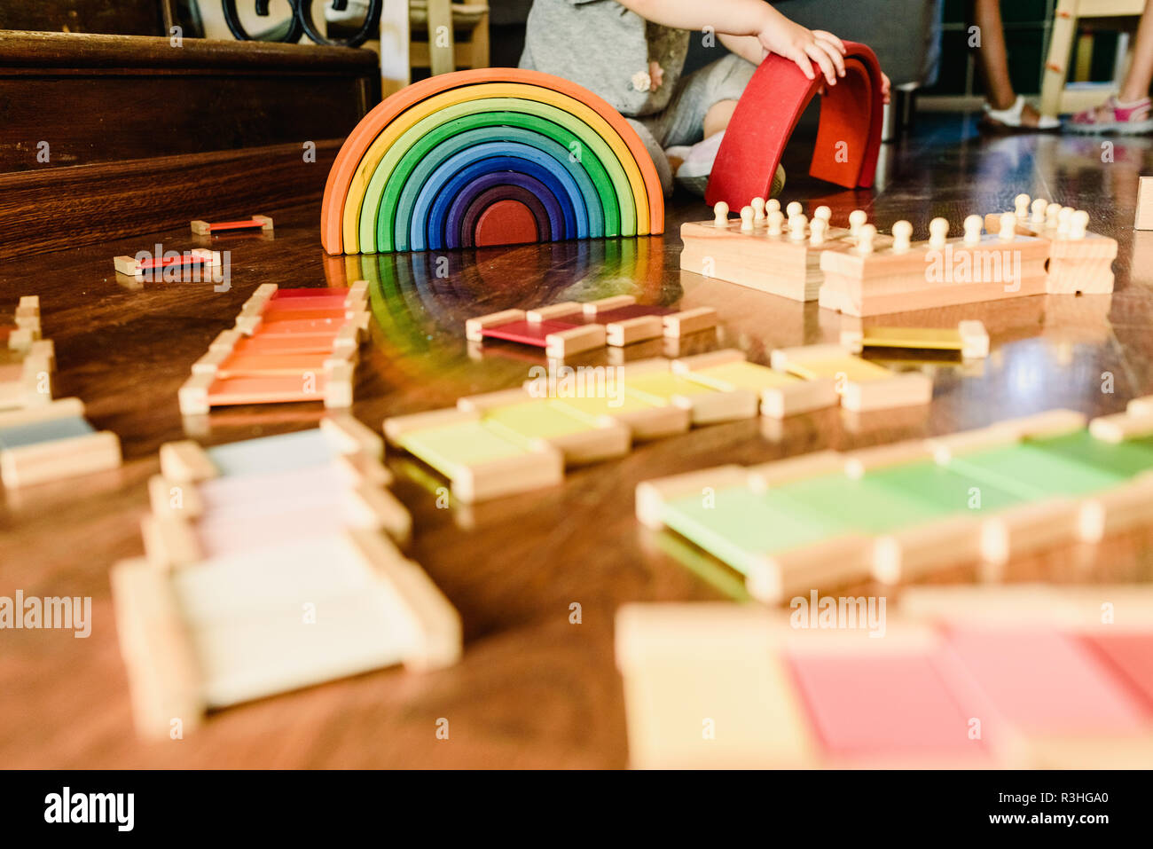 Children playing with wooden rainbow waldorf montessori Stock Photo - Alamy
